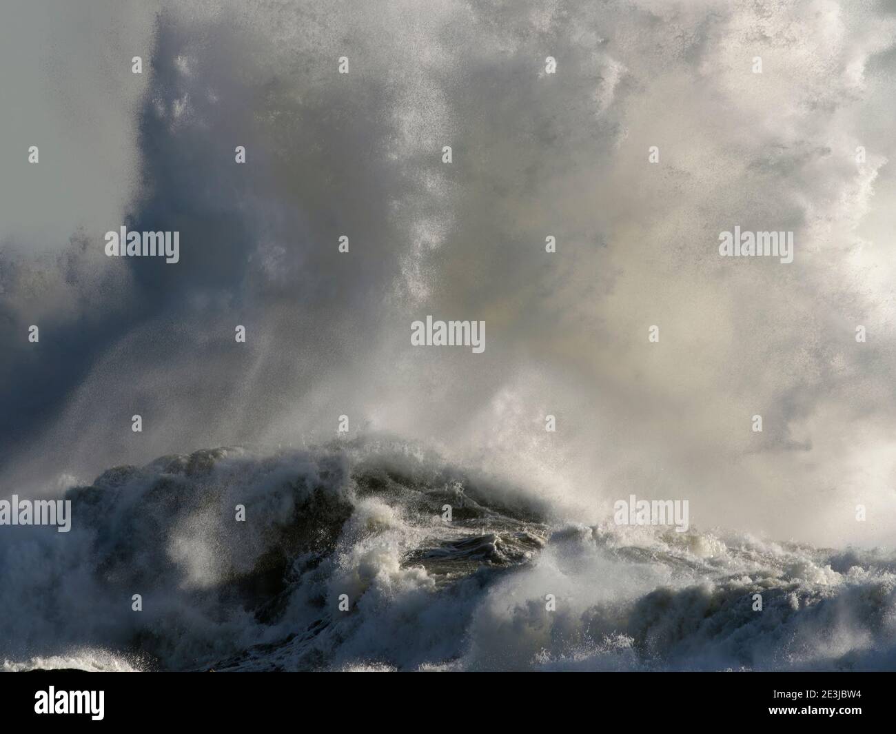 Storm on the coast seeing big wave breaking over rocks and cliffs with ...