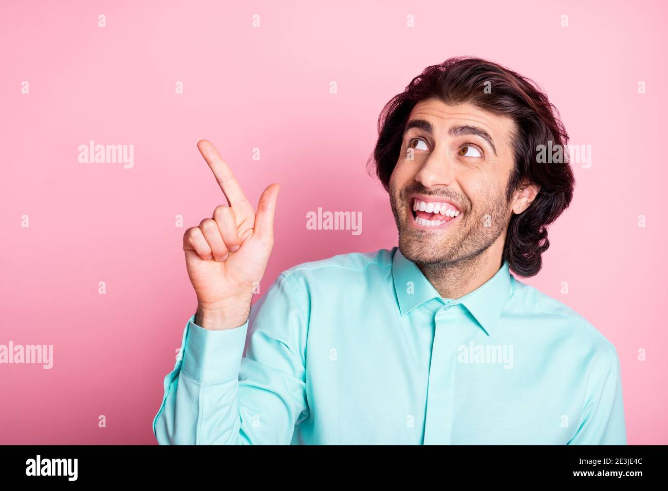 Photo of young attractive happy cheerful man show point index finger ...