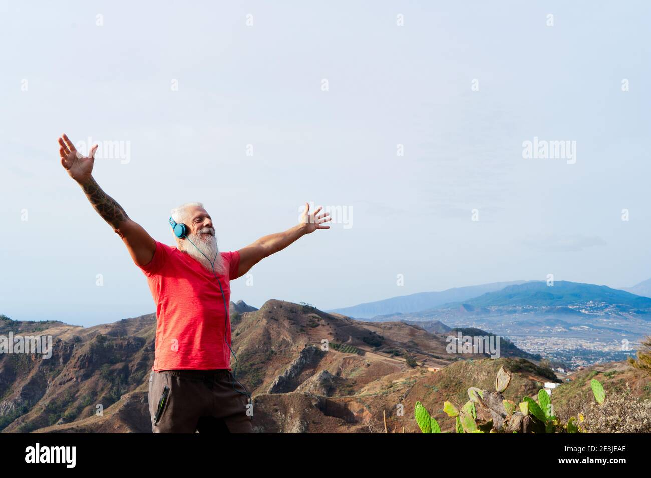 Senior man greeting sunset Stock Photo - Alamy