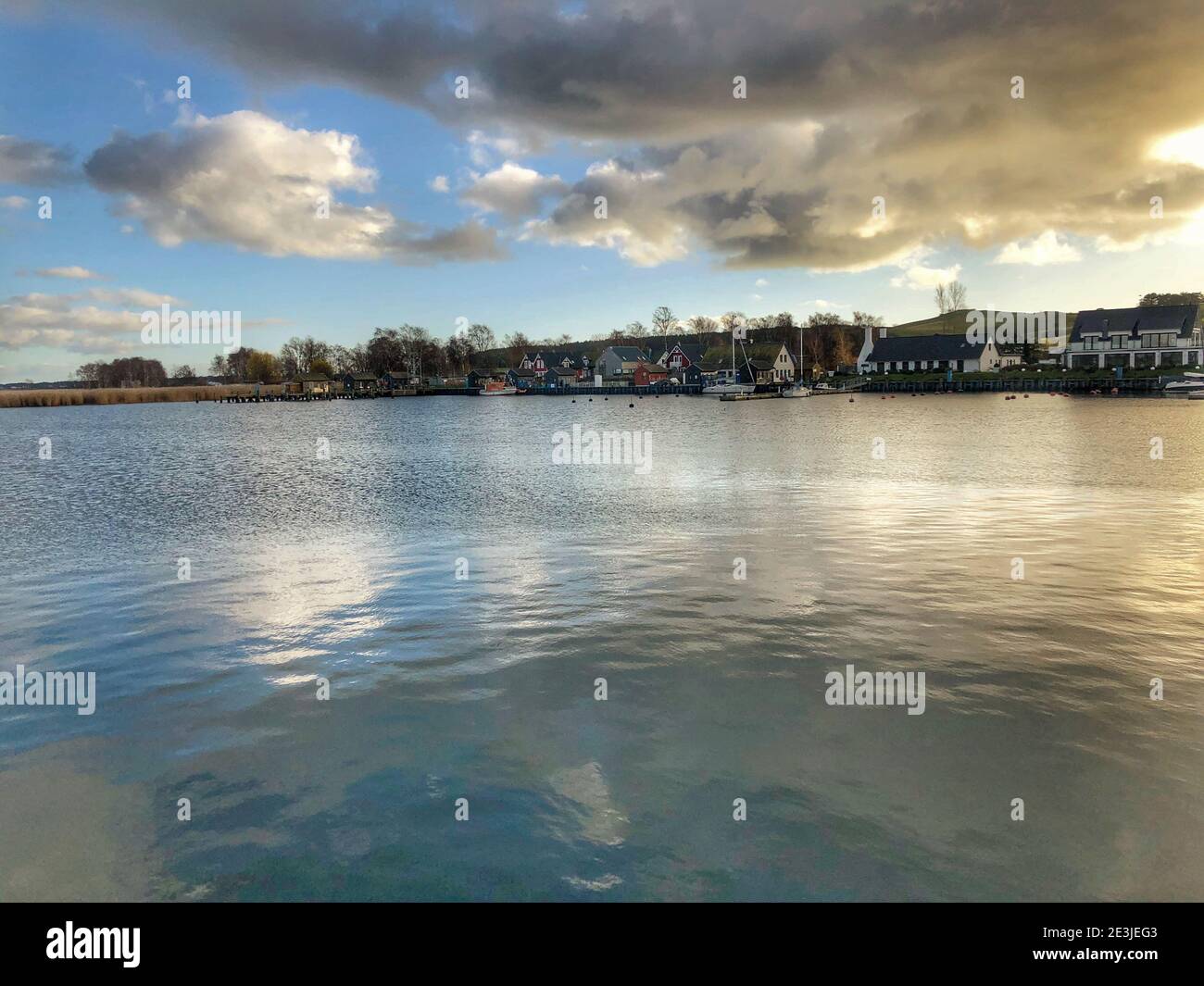 small harbour with small fishing village Stock Photo - Alamy