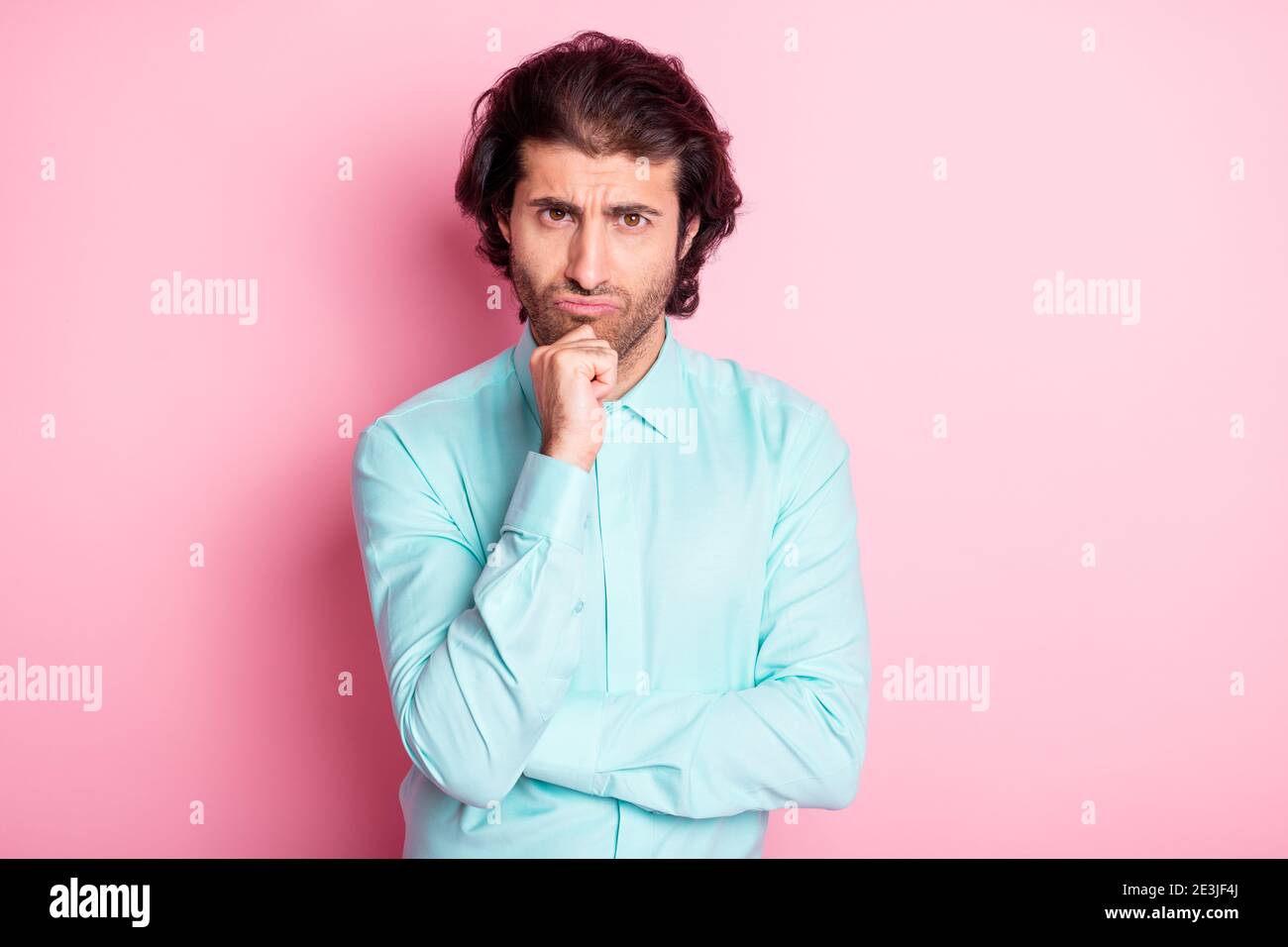 Photo portrait of upset grimacing guy touching face chin with finger ...