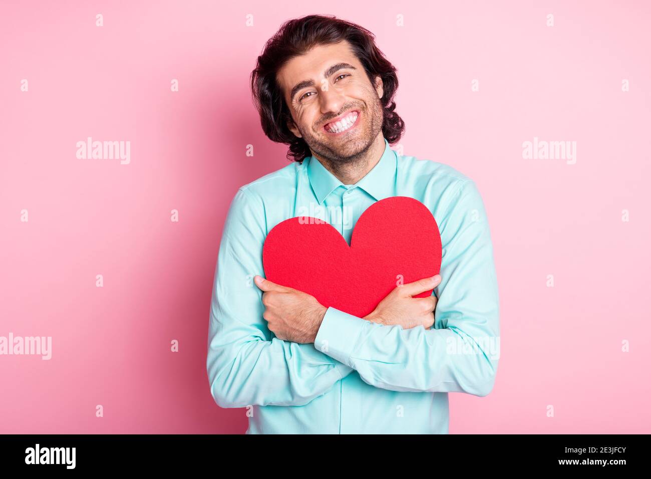 Photo portrait of man hugging big red heart cutout isolated on pastel ...