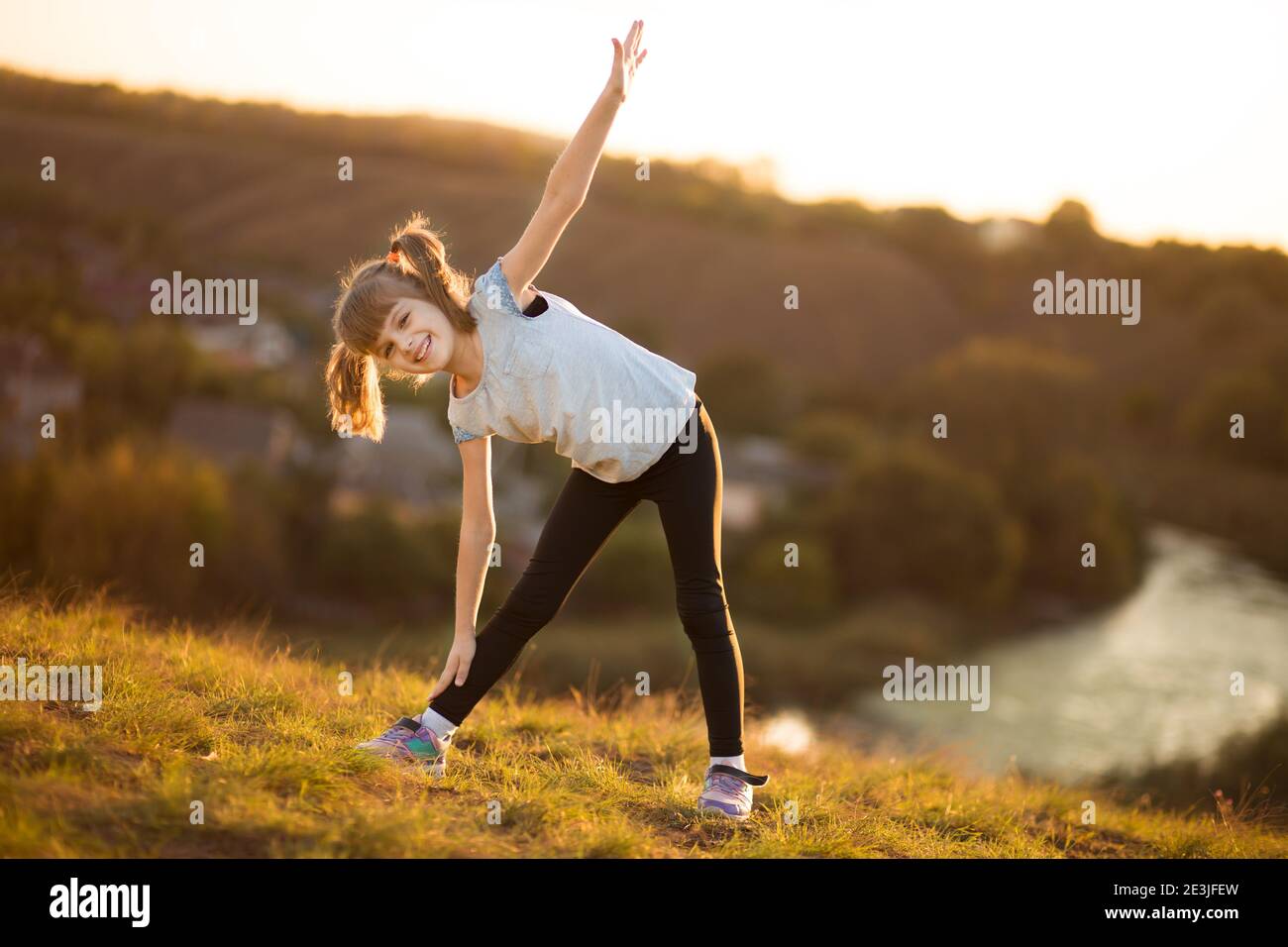 Little girl doing fitness exercises hi-res stock photography and images ...
