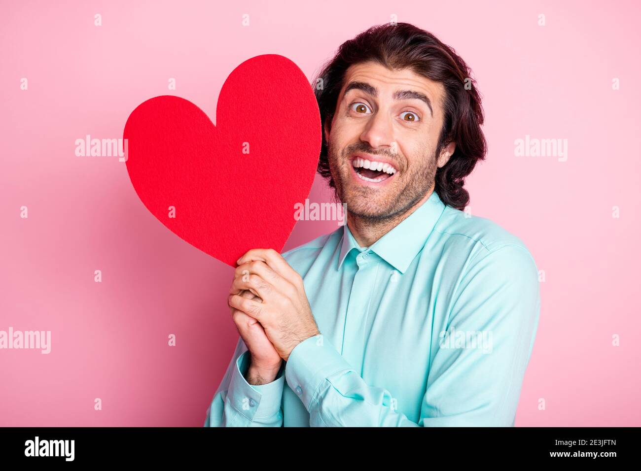 Photo portrait of guy holding big red heart postcard near face isolated ...