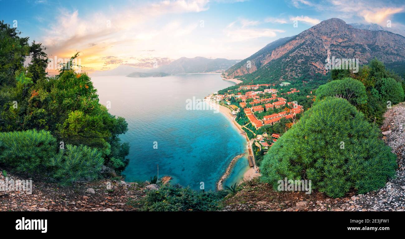 Turquoise lagoon with houses on shore at sunset Stock Photo - Alamy