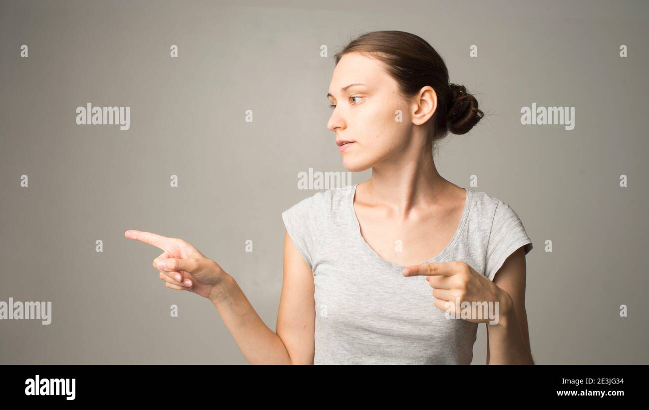 young woman shows something Stock Photo - Alamy
