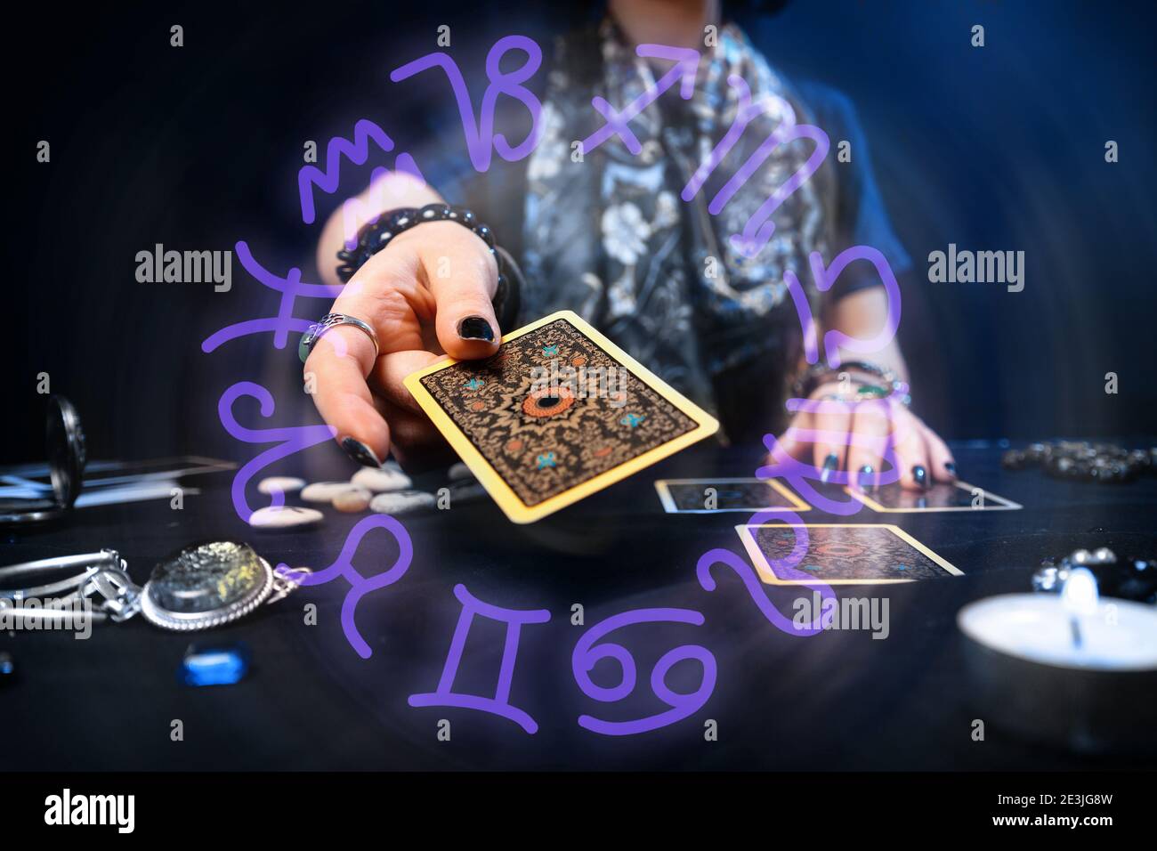 Fortune-telling on cards. The fortune teller hands over a Tarot card ...