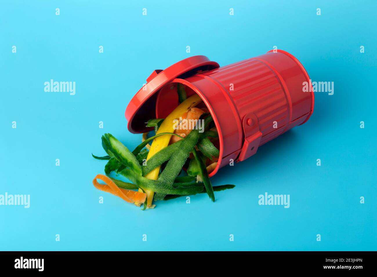 Organic waste in a red trash can. Recycling and sorting of garbage ...