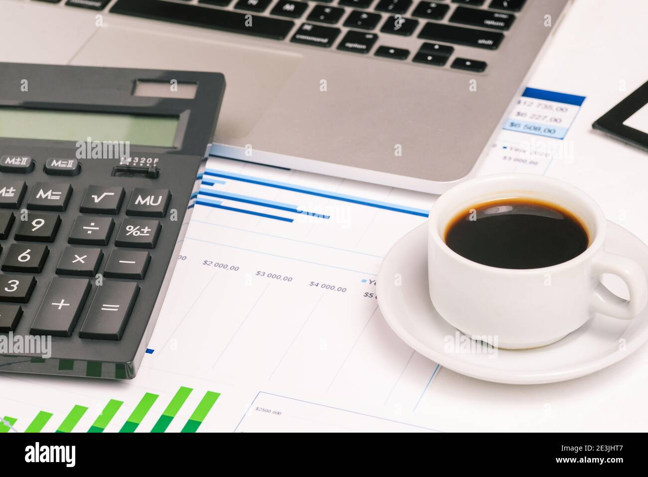 Accounting and analytics. Work desk with a cup of coffee, a computer ...
