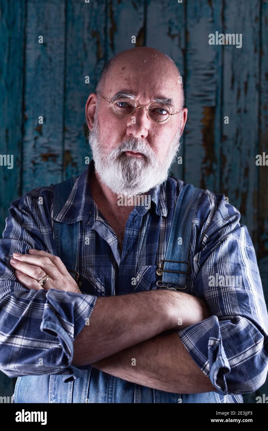 Portrait of an elderly man in bib overalls Stock Photo - Alamy