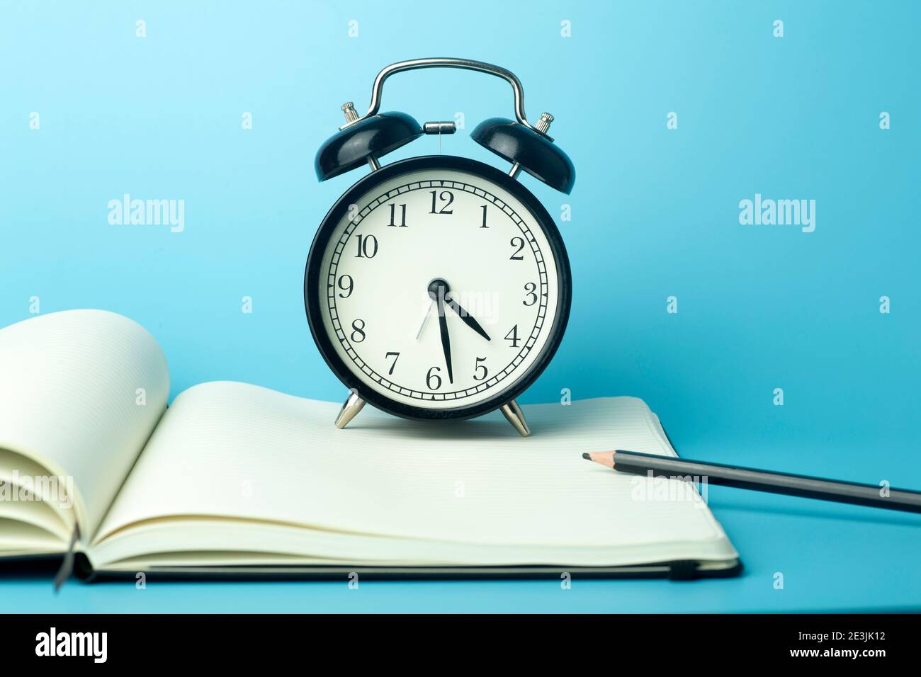 Notepad for sticky notes on desktop with alarm clock. Office desktop ...