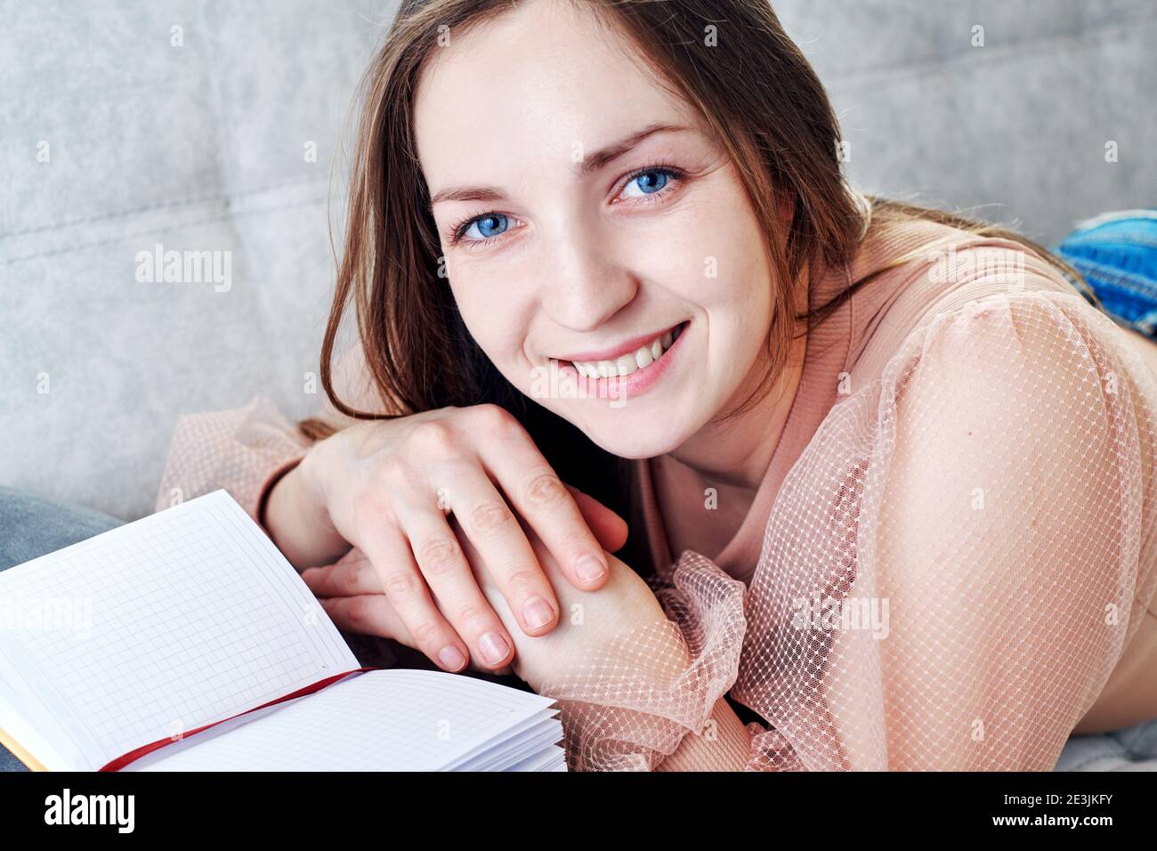 cute young girl reading relaxed on the sofa Stock Photo - Alamy