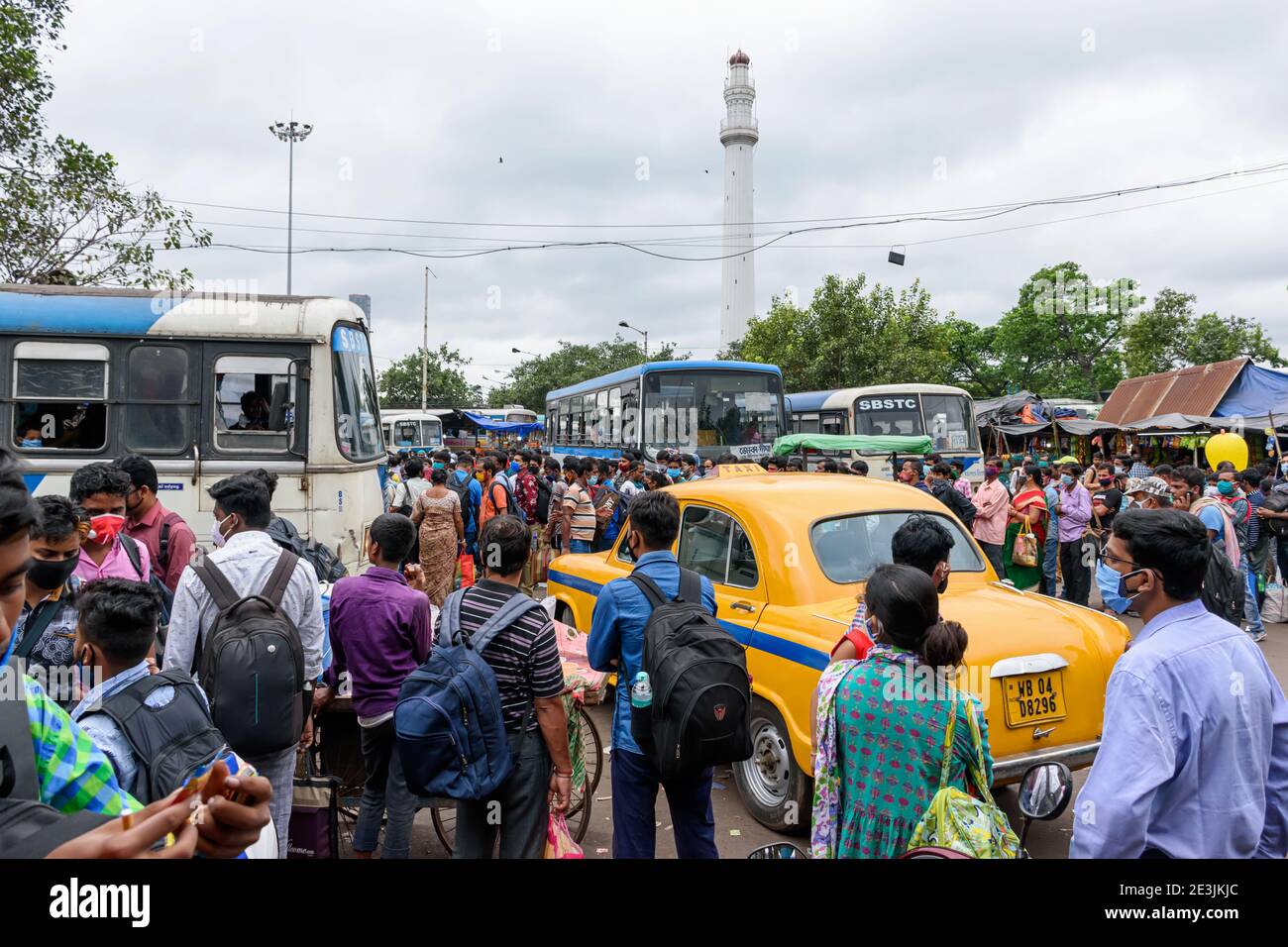 People gathered in the bus stand waiting for the bus with masks during ...