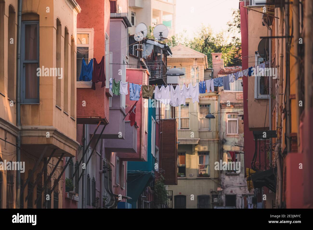 Clothes hang out to a dry amongst a colourful apartment block on ...