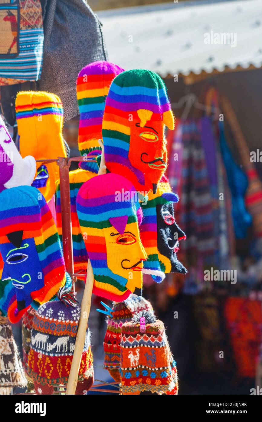 Colourful knitted masks and hats on display for sale in a souvenir ...