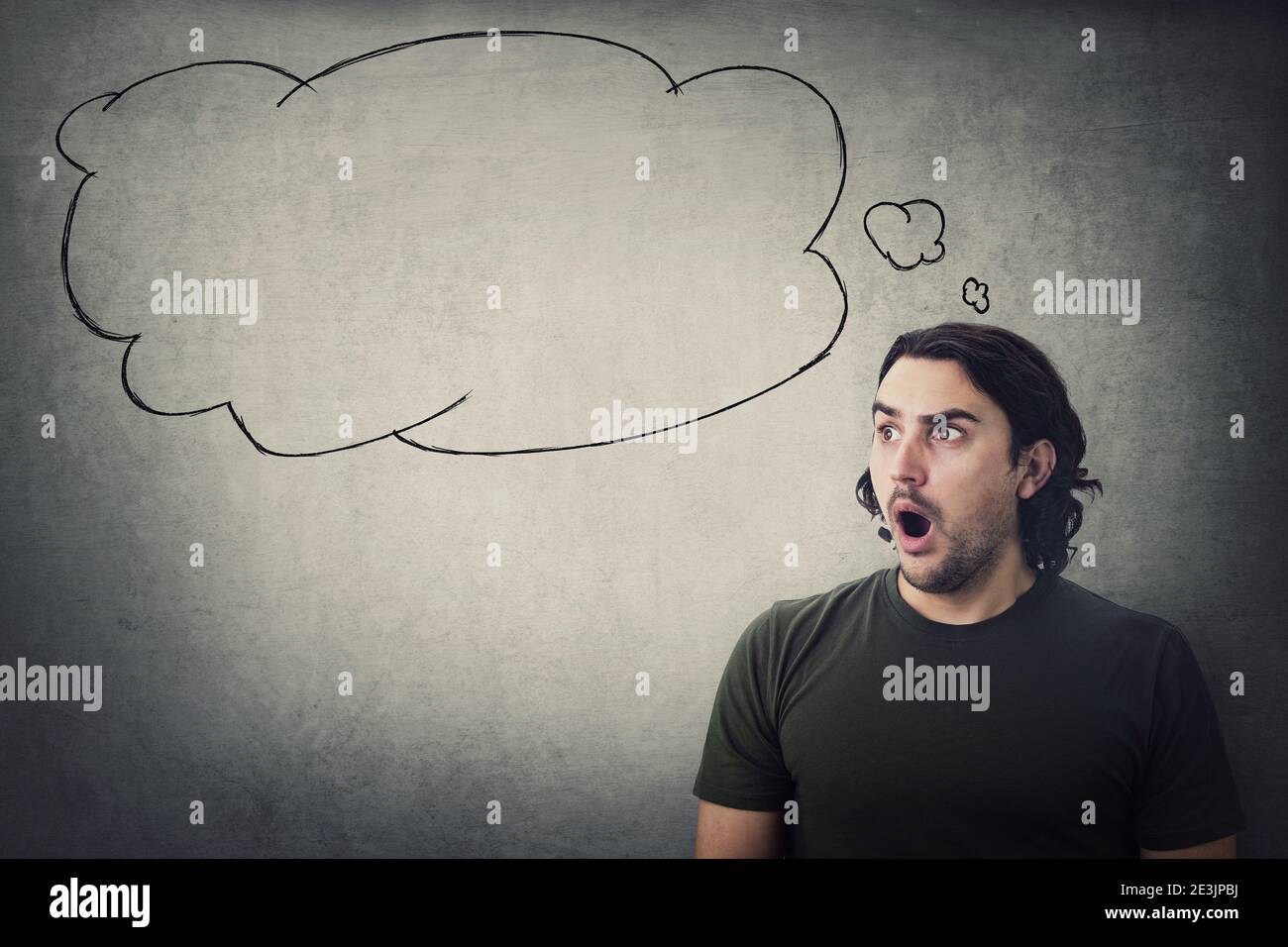 Stunned and shocked man, big eyes looks aside astonished and an empty ...