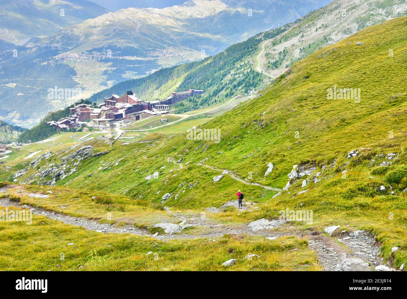 Young woman hiking at French Alps near Arcs 2000 ski station. Summer in ...