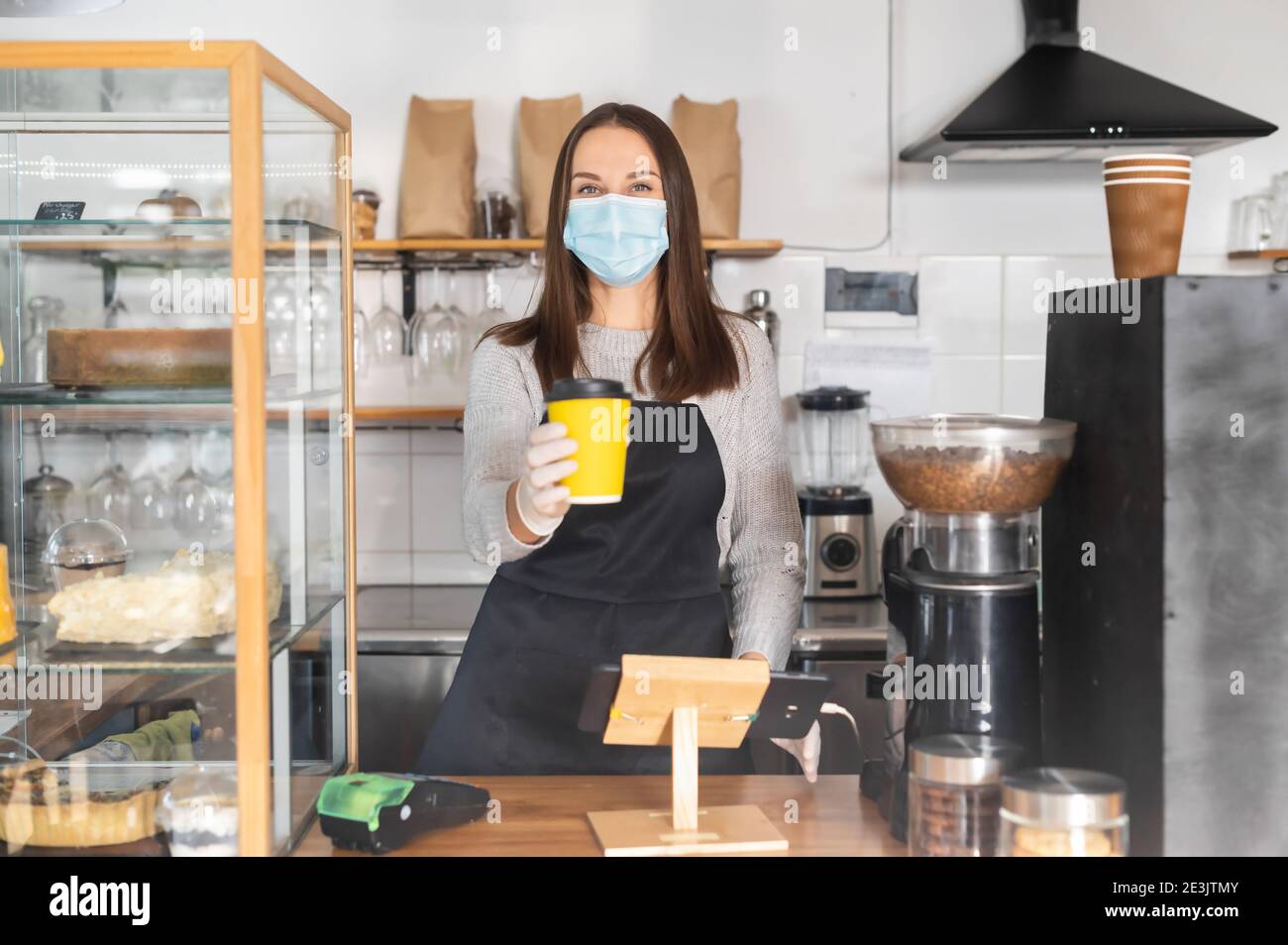 A waitress in a medical mask Stock Photo - Alamy
