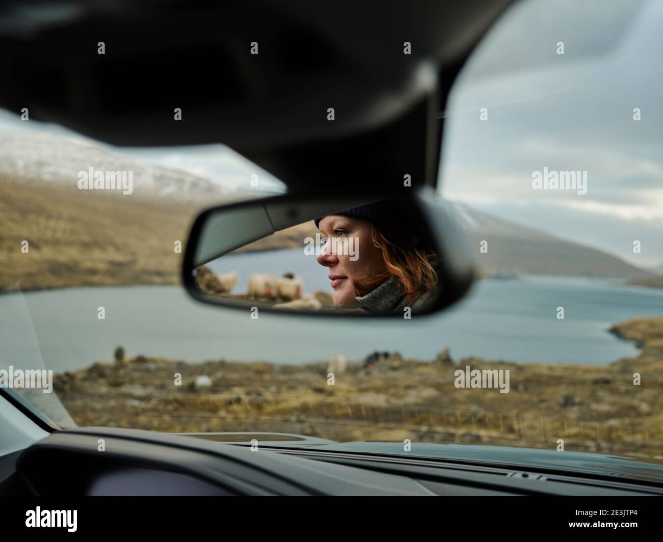 Woman looking through hair in mirror hi-res stock photography and ...