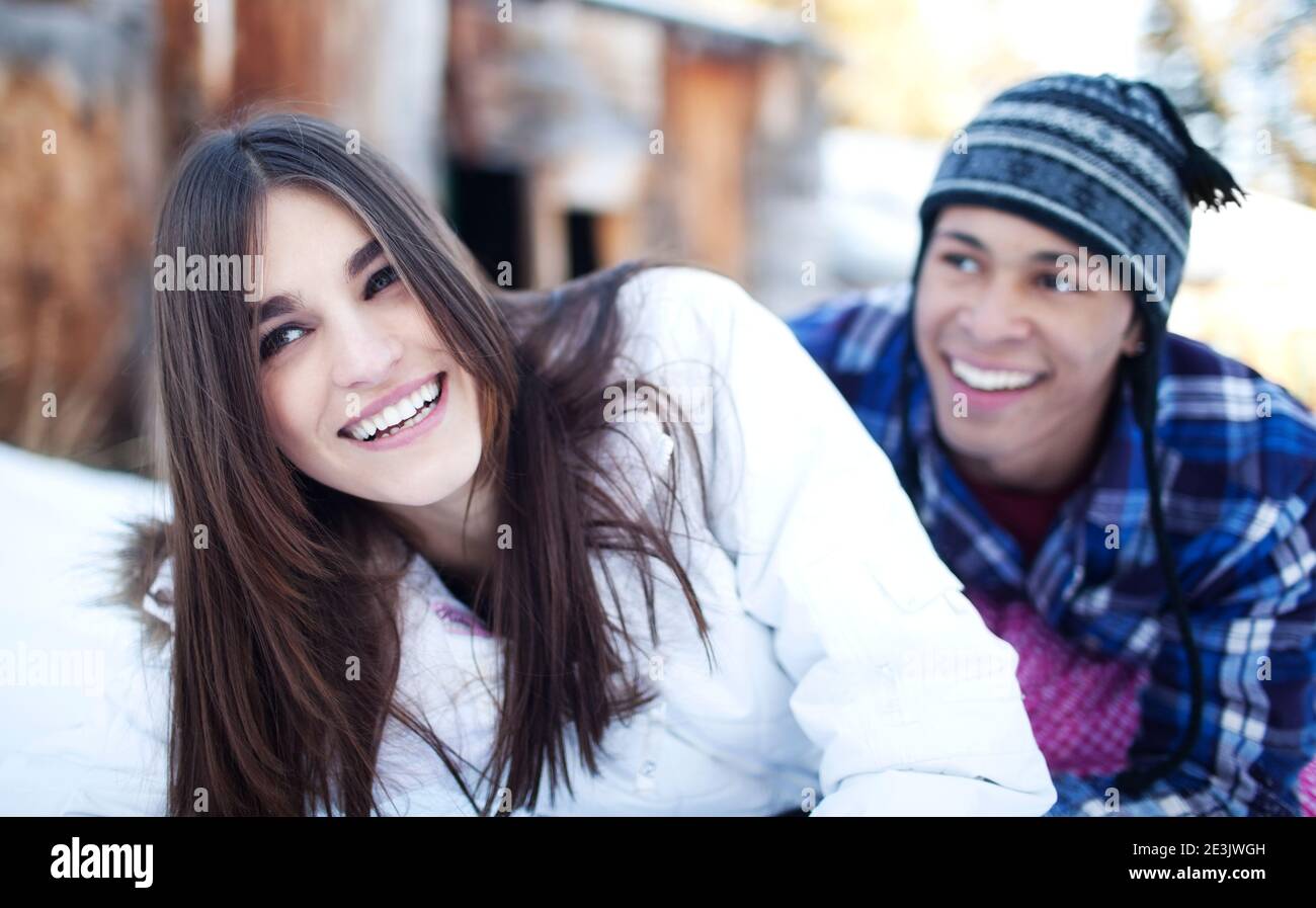 Man playfully tackling woman in snow Stock Photo - Alamy