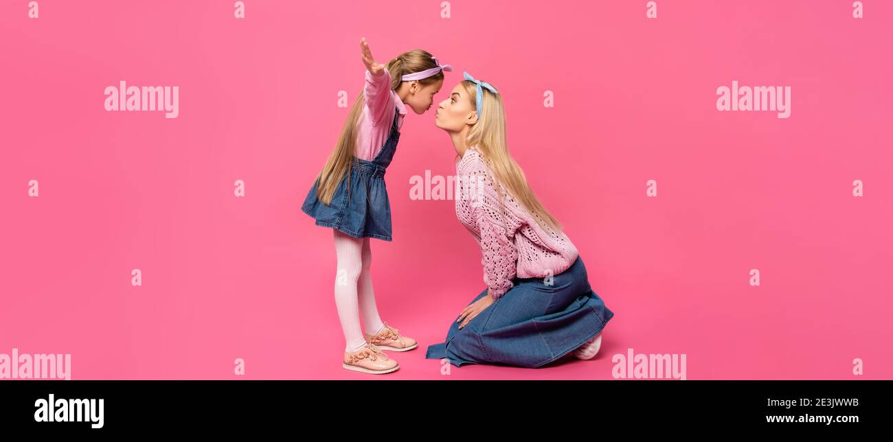 side view of kid puffing cheeks while standing with outstretched hands ...