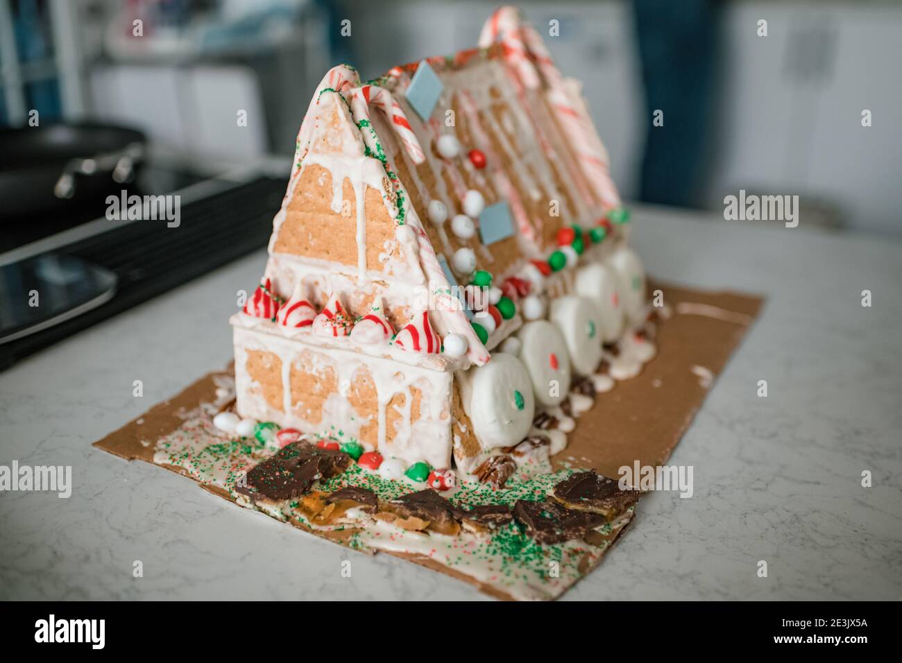 Completed gingerbread house messy on kitchen counter Stock Photo - Alamy