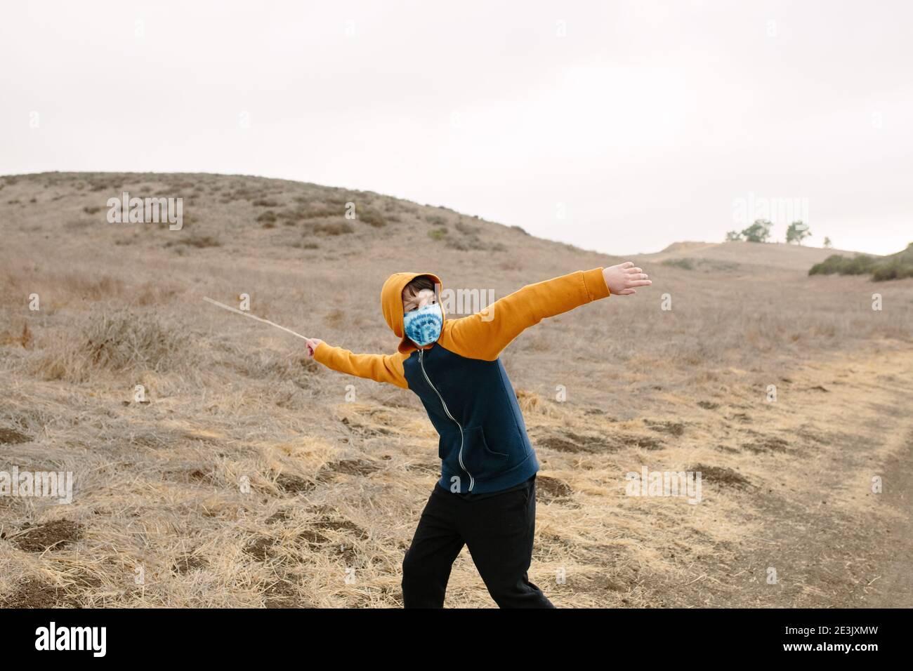 Boy On A Trail Wearing A Cloth Face Mask Gets Ready To Throw A stick ...