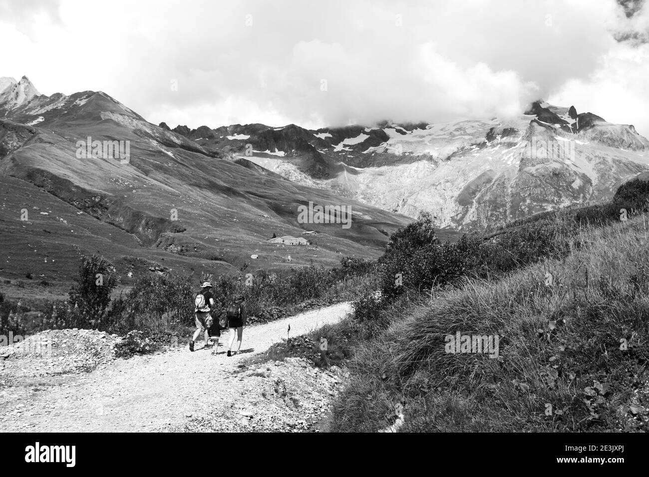 Family with little child hiking in French Alps in summer. The Aiguille ...