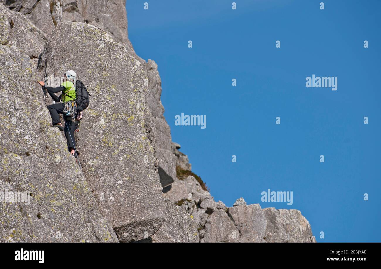 man climbing up rock face on Tryfan in North Wales Stock Photo - Alamy
