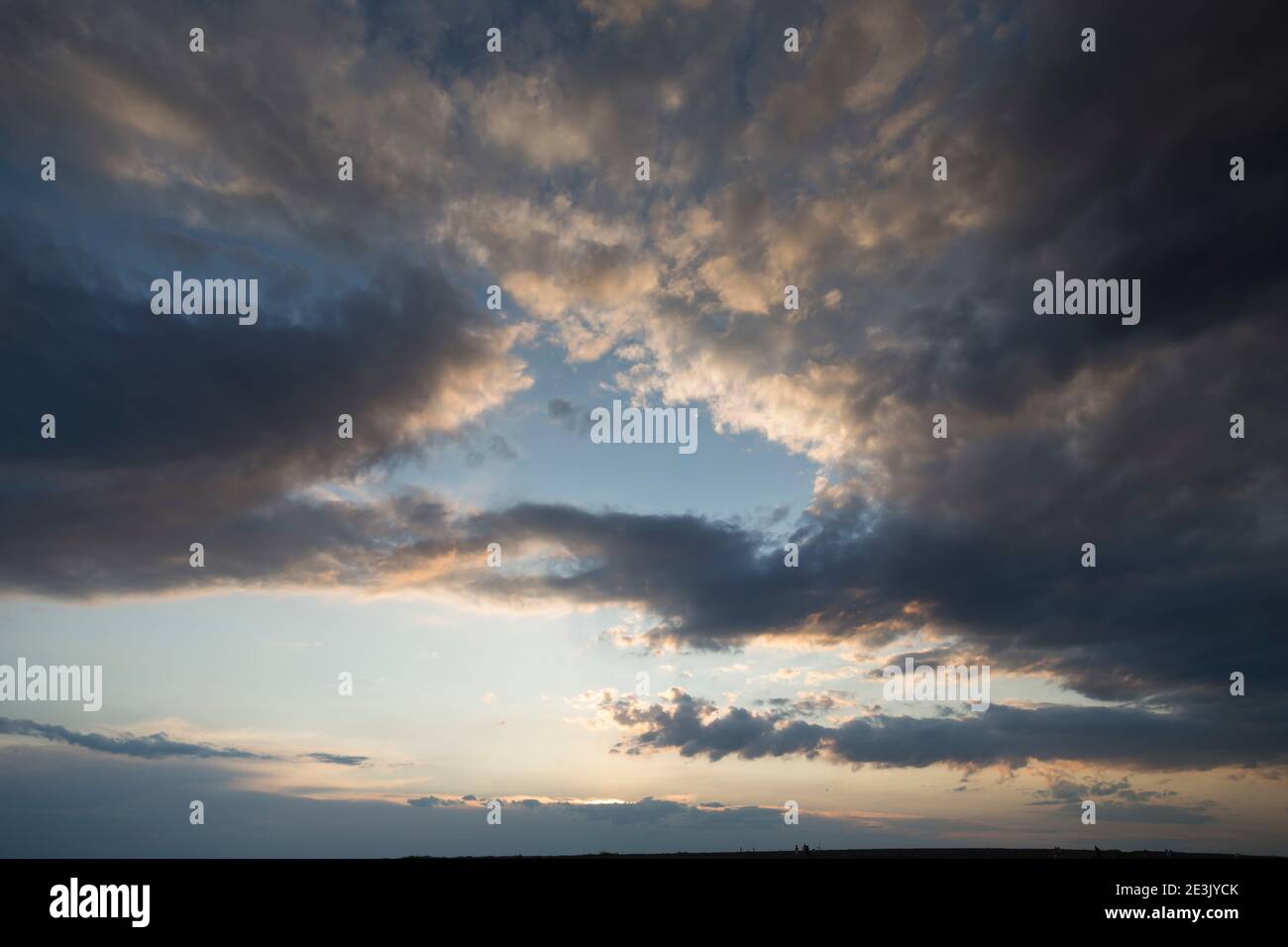 Dramatic sky in the rays of the setting sun. A unique phenomenon of ...