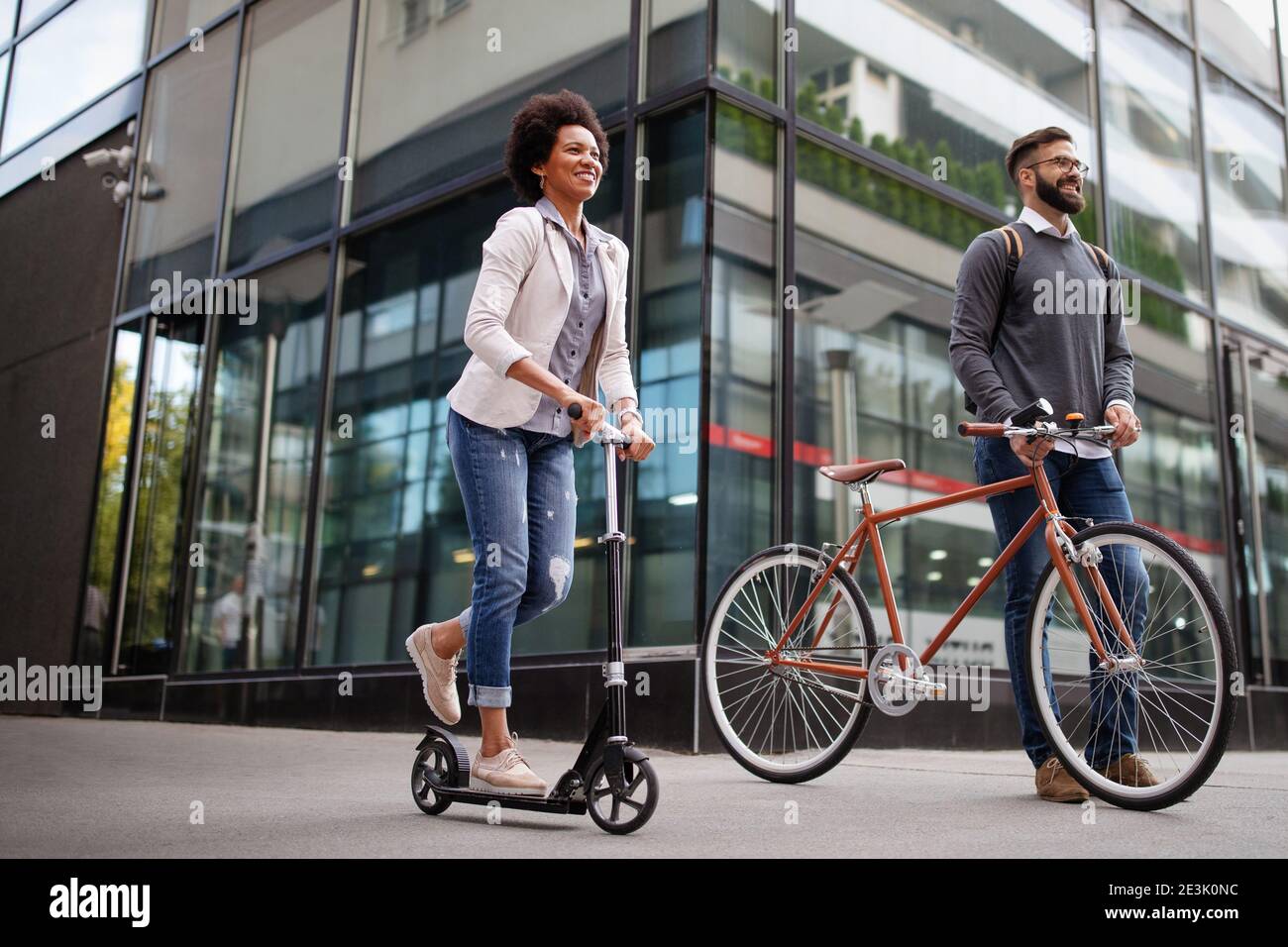Happy business people going to work with bicycle, electric scooter on ...