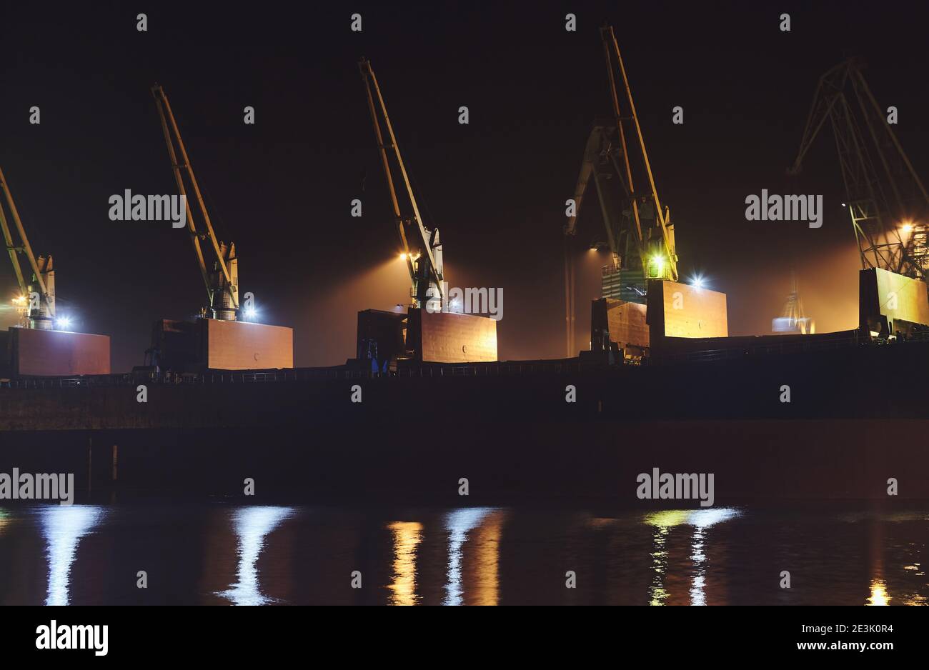 Bulk carrier unloading at a foggy night Stock Photo - Alamy