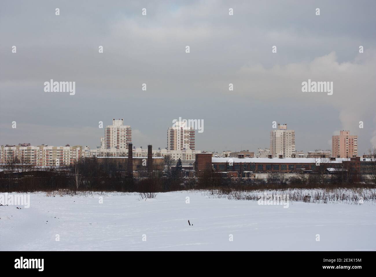 Winter city landscape. Wasteland covered with snow. On the horizon are ...
