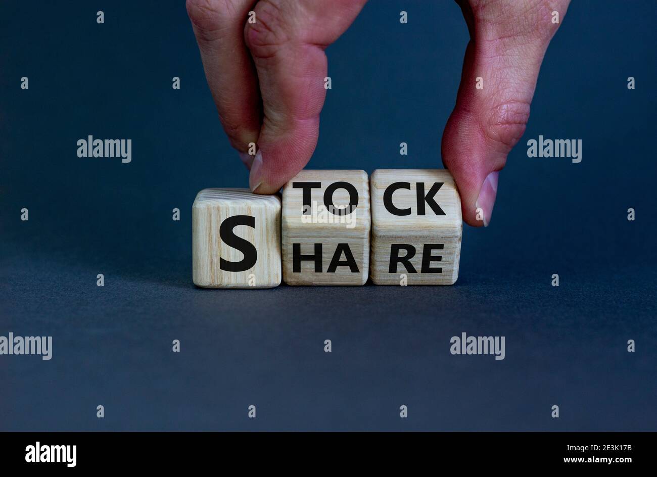 Stock vs share symbol. Businessman turns cubes and changes the word ...