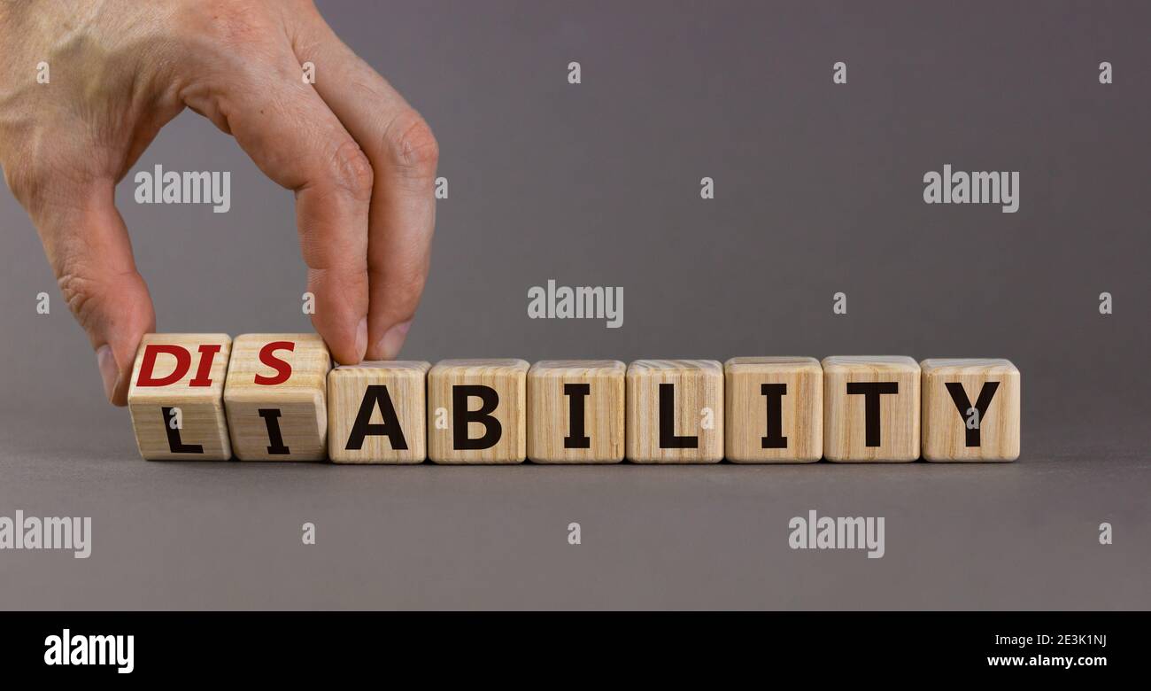 Liability or disability symbol. Businessman turns cubes and changes the ...