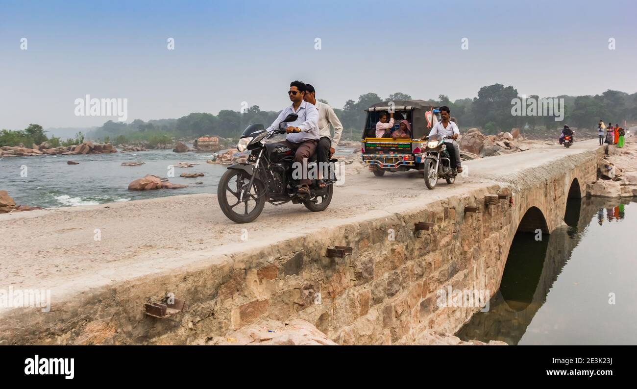Young men on a motorcycle crossing the bridge in Orchha, India Stock ...