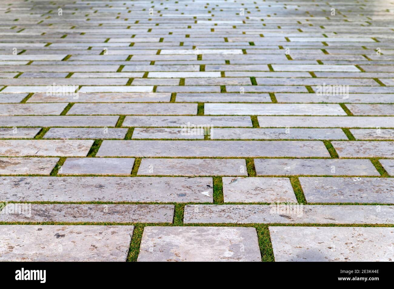 ANKARA, TURKEY - 14 DECEMBER 2020: close up of paving stone with grass ...