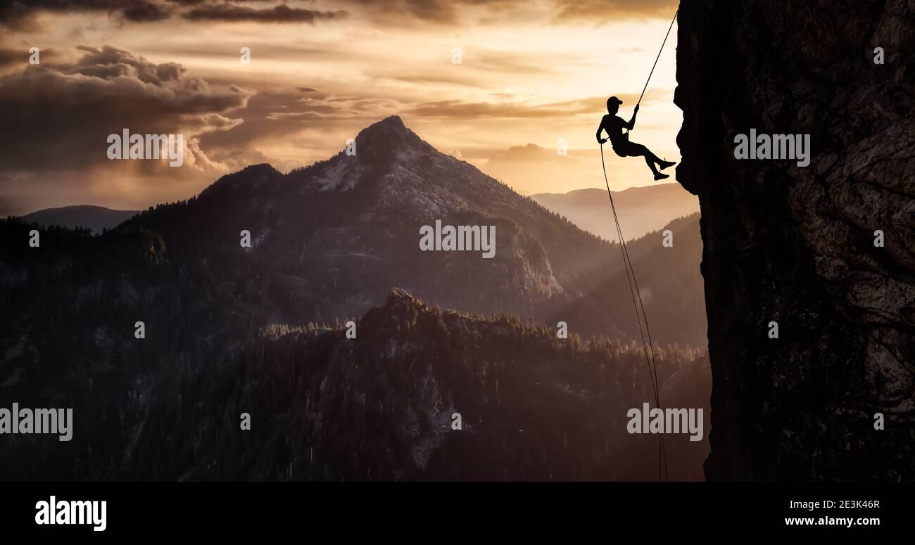 Silhouette Rappelling from Cliff Stock Photo - Alamy