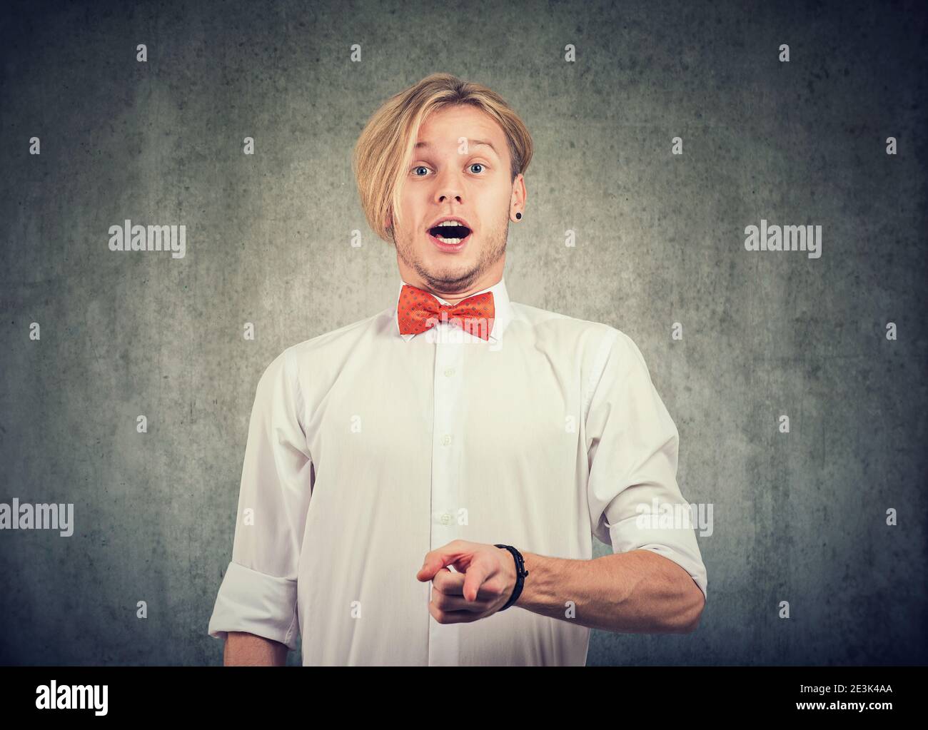 Portrait of a surprised young man pointing with finger at camera Stock ...