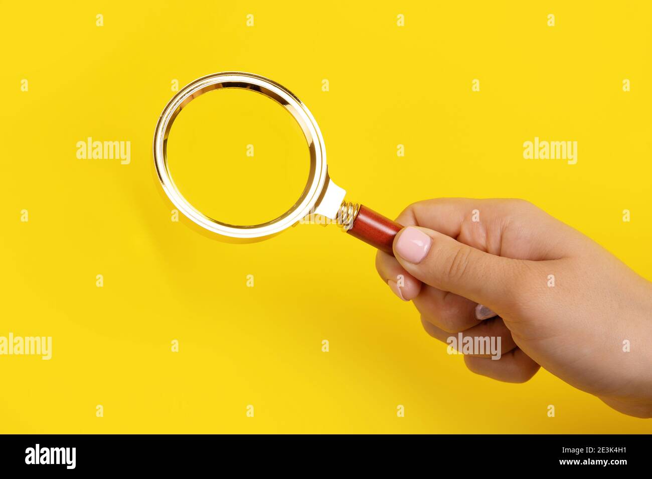 hand holding magnifier over yellow background, search concept Stock ...