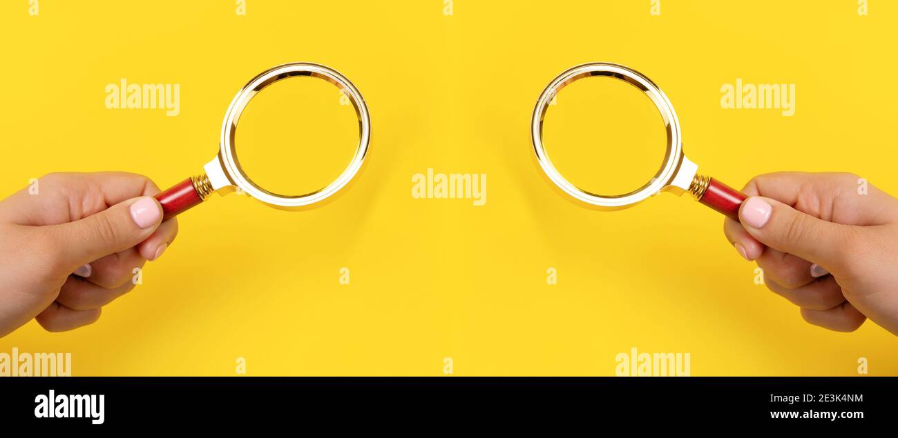magnifier in hand on yellow background, panoramic image Stock Photo - Alamy