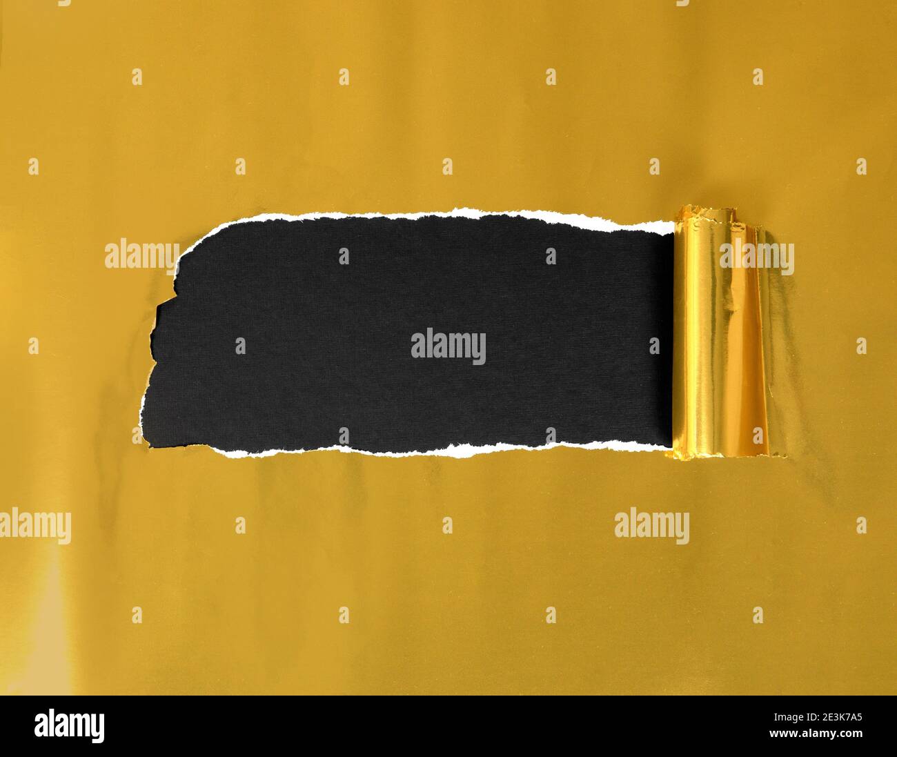 Shiny gold ripped torn paper against black background texture, copy ...