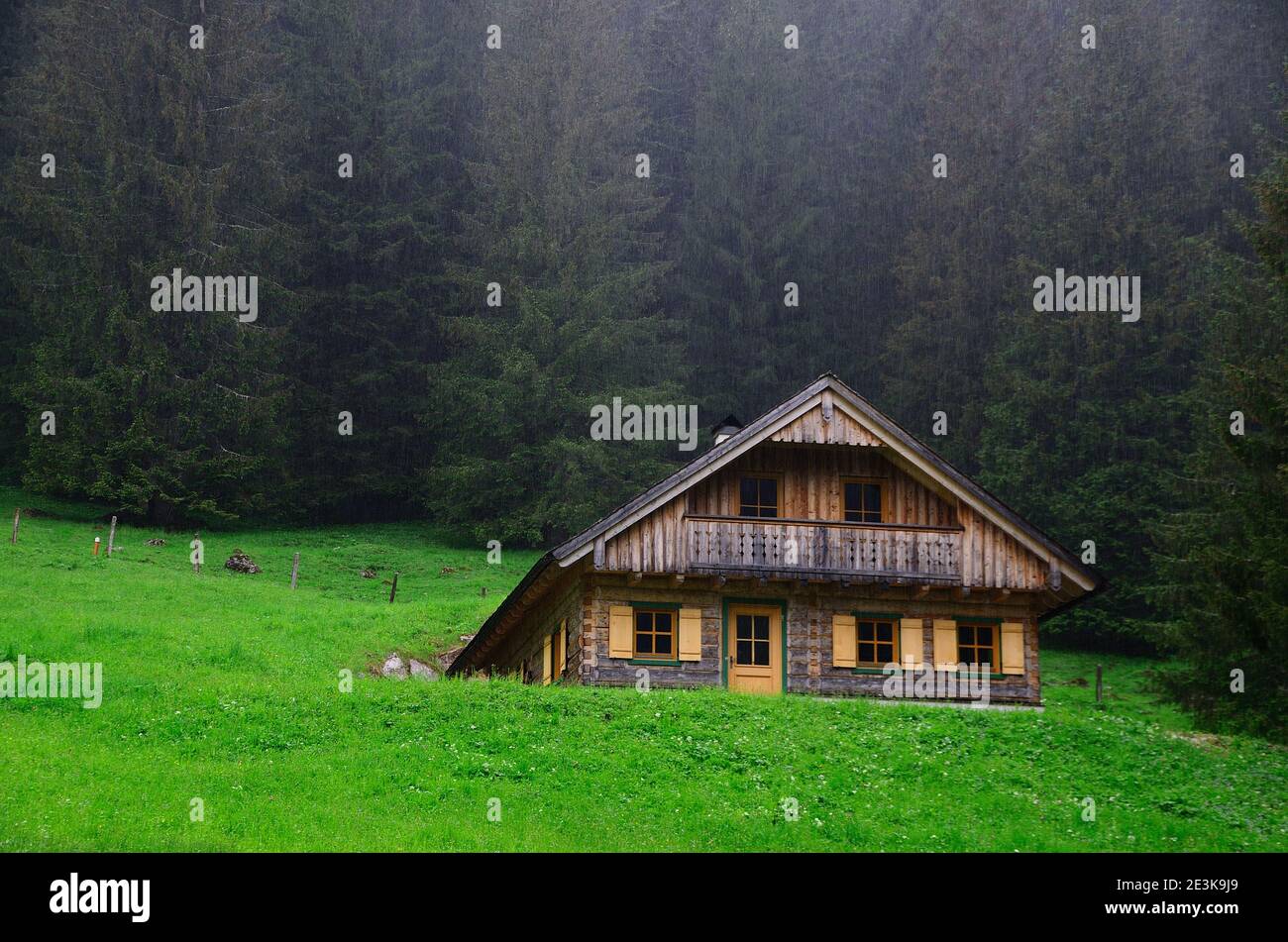 beautiful old wooden house in the mountains and heavy rain Stock Photo ...