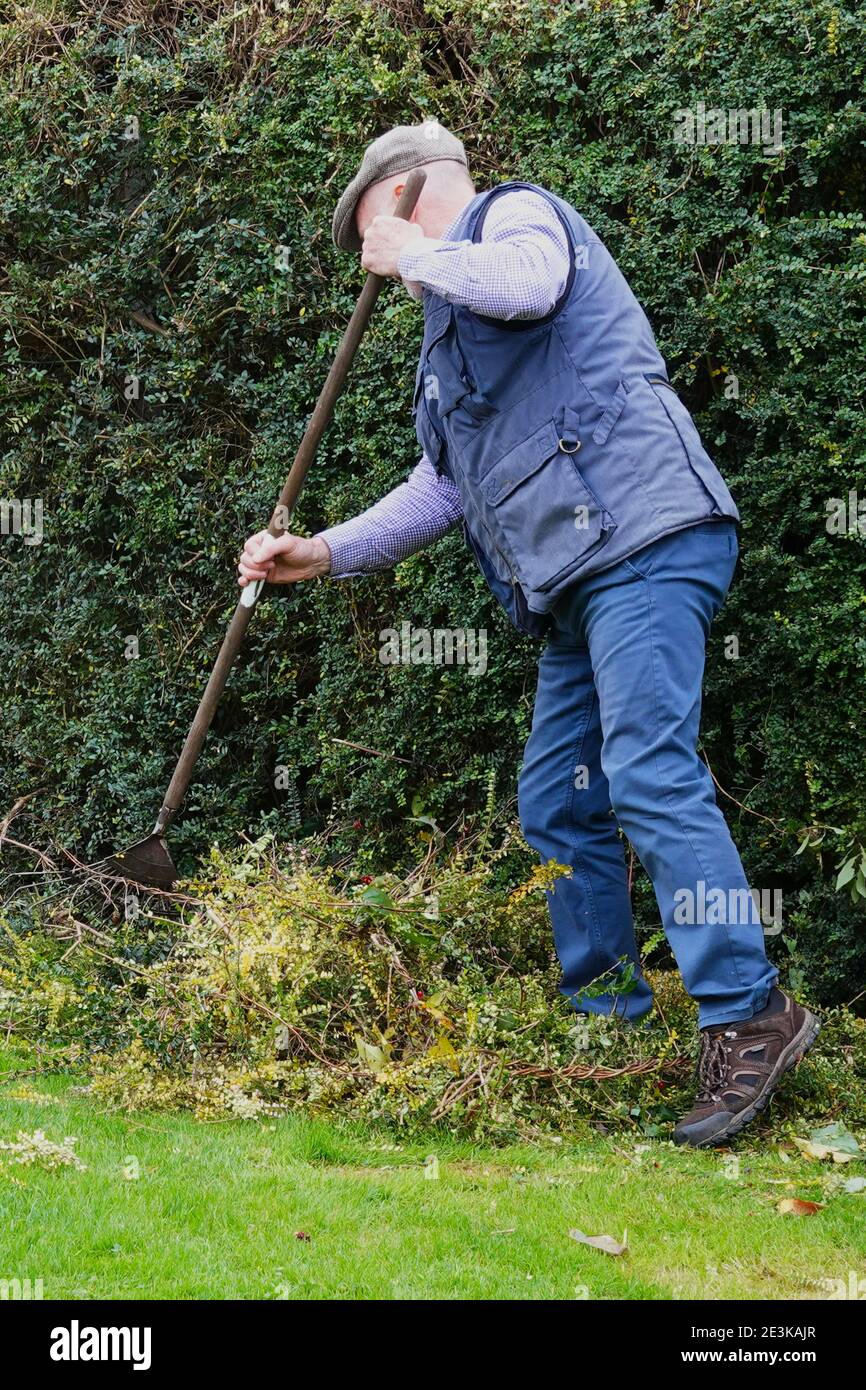 Male raking grass hi-res stock photography and images - Alamy