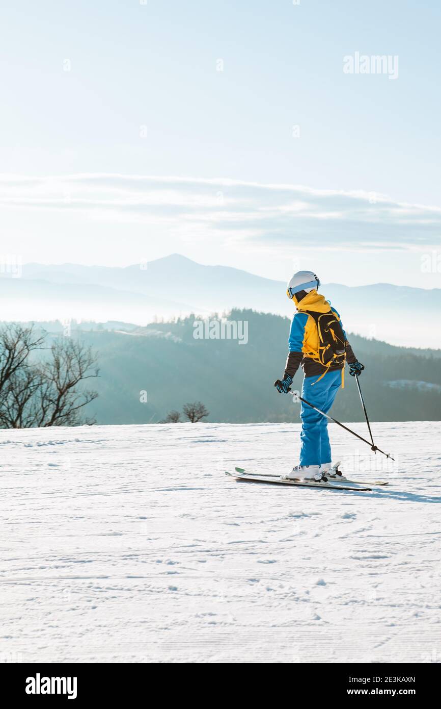 woman sliding down by slope on skies copy space Stock Photo - Alamy