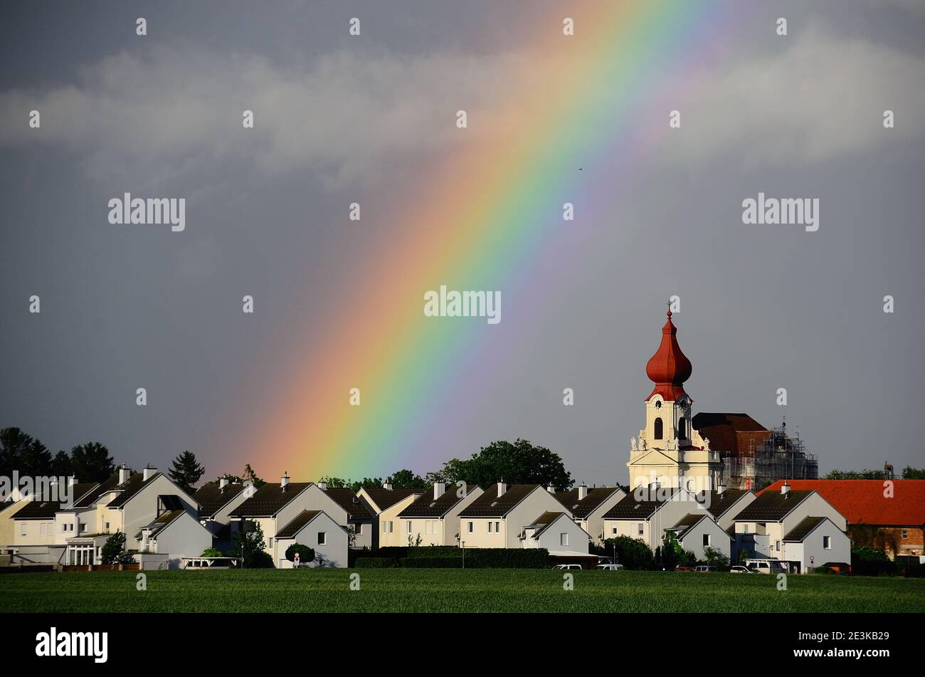 colorful rainbow in a village with beautiful church Stock Photo - Alamy