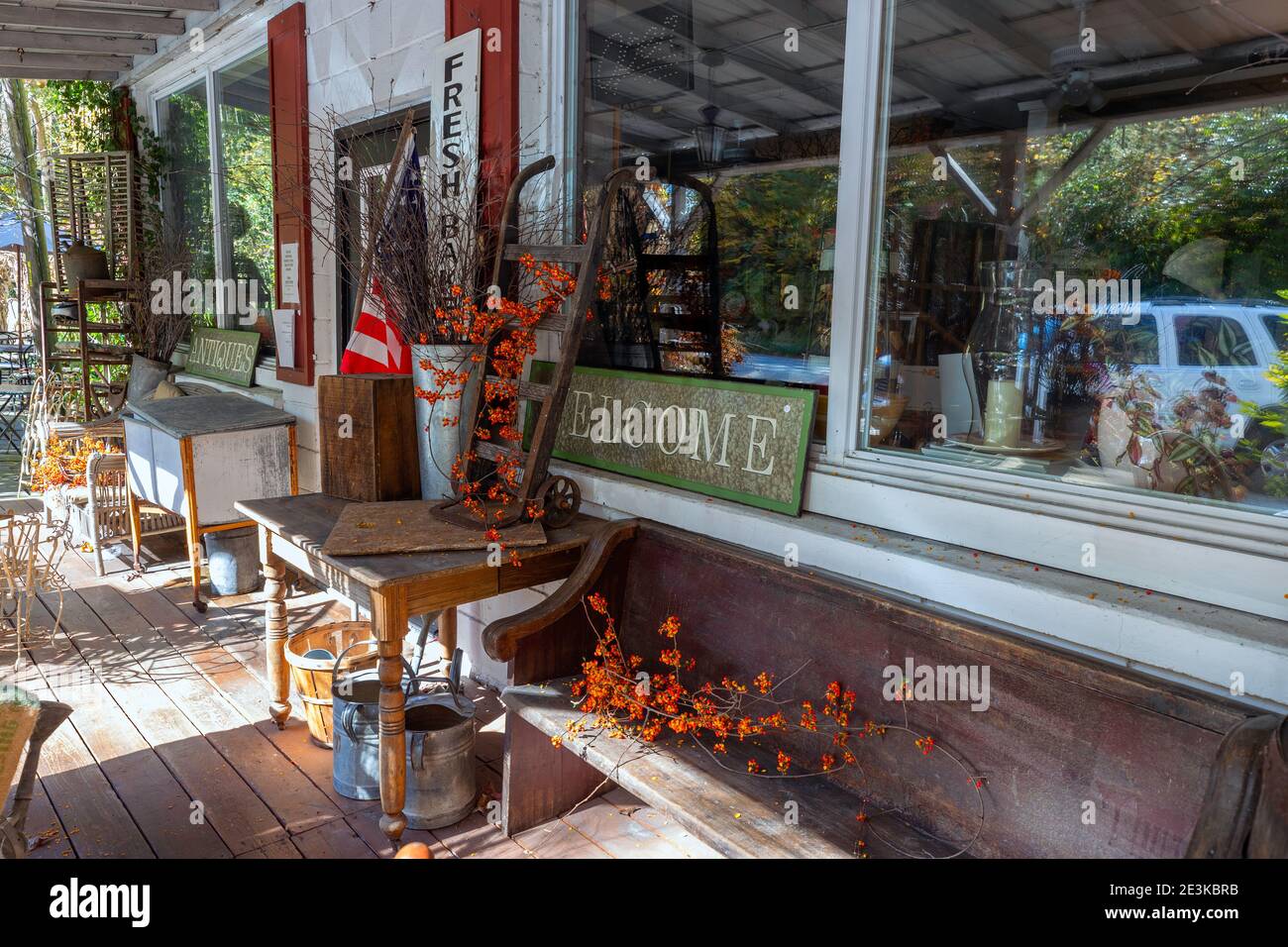 Old rustic antiques on display outside an old building Stock Photo - Alamy