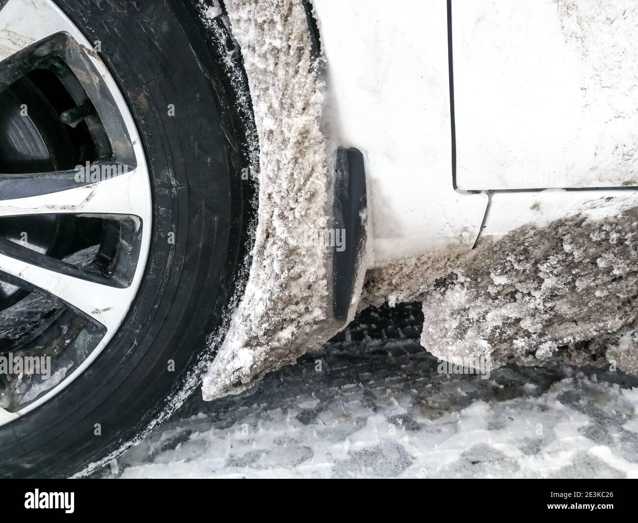 The wheel arch of the car is clogged with ice and snow. Consequences of ...