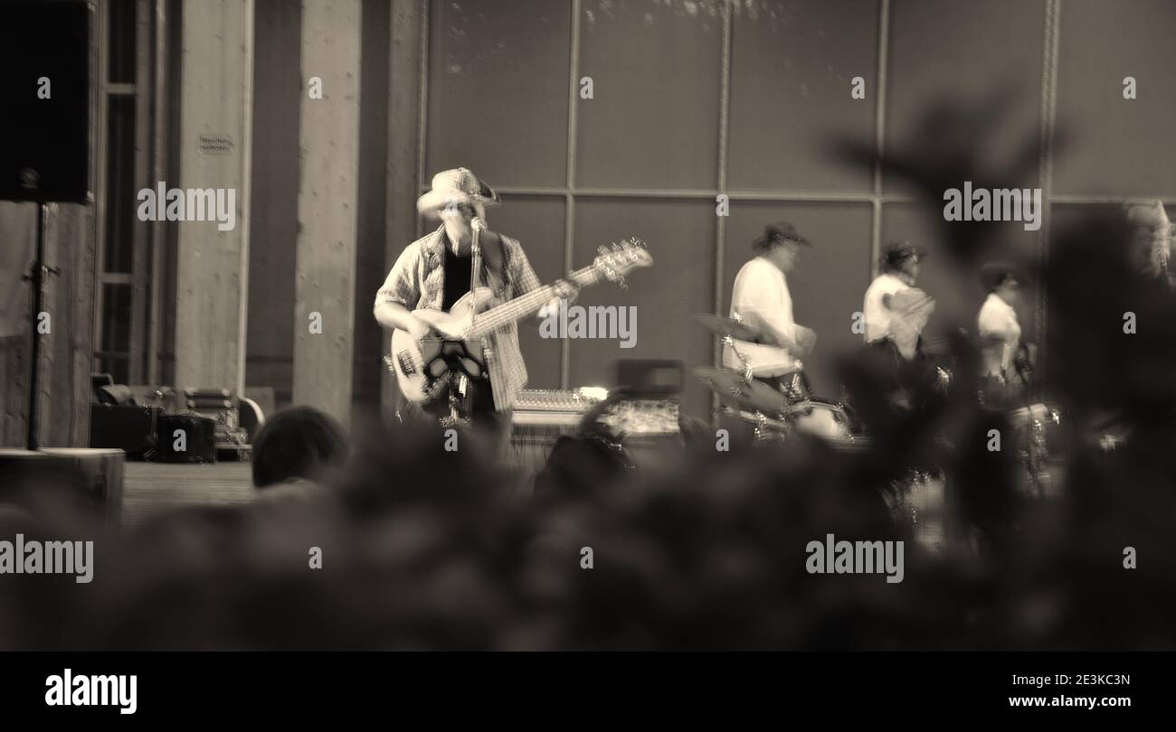 bass player of a country band with line dancers in the background Stock ...