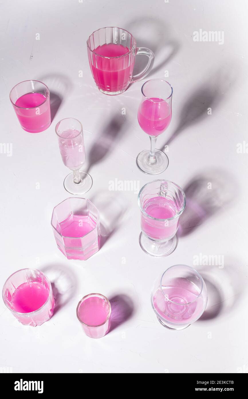 Set of glasses with rose water on a white background Stock Photo - Alamy